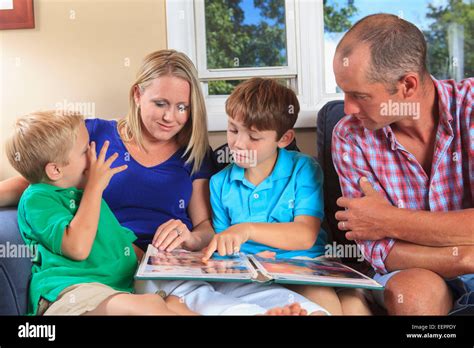 Familia con deficiencias auditivas viendo el álbum de fotos y la firma