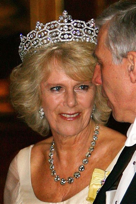 An Older Man And Woman In Formal Wear Are Smiling At Each Other While