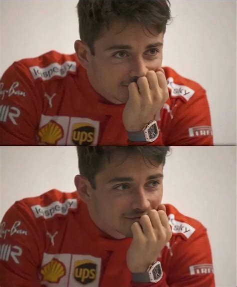 A Man In Red Shirt Holding His Hand To His Face