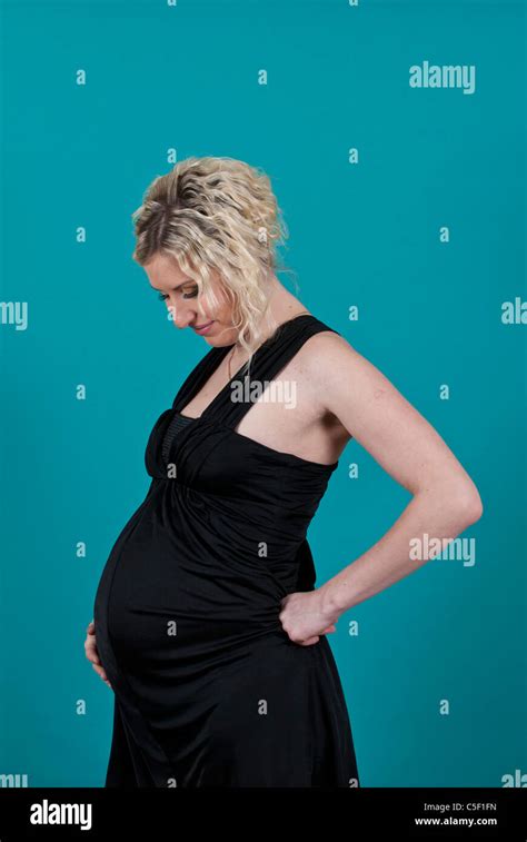 Pregnant Woman Looking At Her Belly Stock Photo Alamy