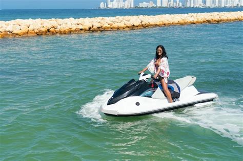 premium photo african american woman in bikini standing on an jet ski