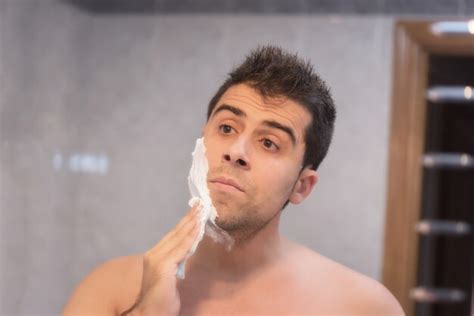 Premium Photo Handsome Man Shaving His Beard In Bathroom