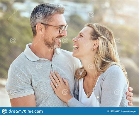 happy and loving mature caucasian couple enjoying a romantic date at the beach together on a