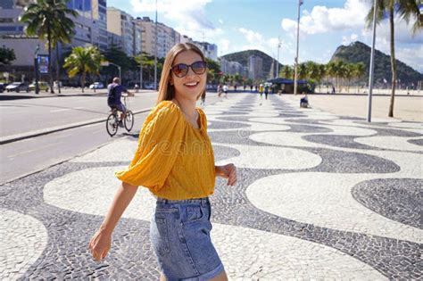 Happy Smiling Woman Walking Along Copacabana Beach Promenade And Turns