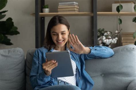 Close Up Smiling Woman Waving Hand Holding Computer Tablet Stock Photo