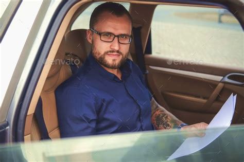Bearded Businessman Sitting On A Back Seat In The Luxury Car Business
