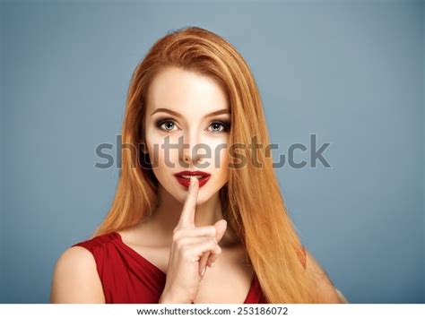 Beauty Portrait Of Sexy Woman With Finger On Her Red Lips Showing Hush Long Hair Holiday