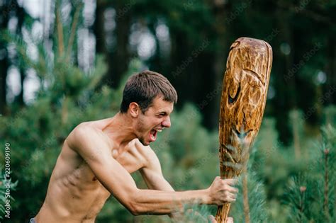 Odd Primitive Naked Man With Huge Wooden Stick Hunting In Forest Adult