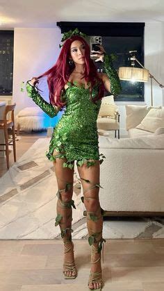 A Woman In A Green Dress Taking A Selfie