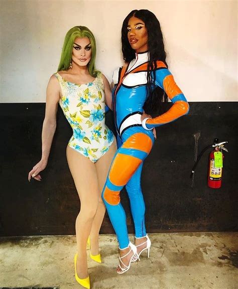 Two Women In Bodysuits Standing Next To Each Other