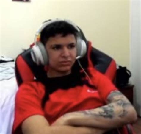 A Man With Headphones Sitting On A Bed