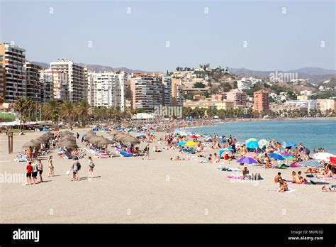 Sunbathers Tourists And Locals Enjoying The Sun Sea And Sand At Playa