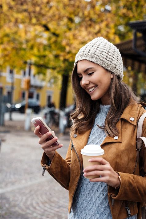 Woman Using A Mobile Phone In The City By Stocksy Contributor Mauro