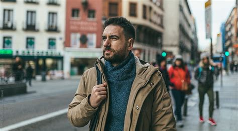 Handsome Bearded Man With Brown Coat In An Urban Scenery Del