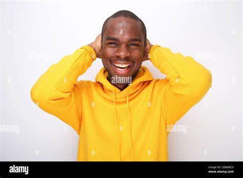 Portrait Of Happy African American Man Laughing With Hands Behind Head By White Background Stock
