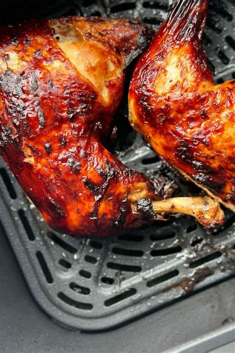 Two Pieces Of Chicken Sitting On Top Of A Grill