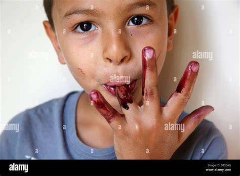 Boy Licking His Fingers Stock Photo Alamy