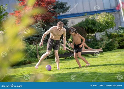 Son And Dad Playing Soccer On Sunny Lawn Stock Photo Image Of Ball