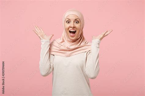Surprised Amazed Young Arabian Muslim Woman In Hijab Light Clothes Posing Isolated On Pink