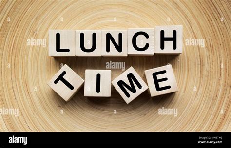 Wooden Blocks With The Text Lunch Time On A Wooden Plate Stock Photo