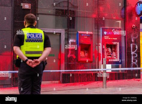 Leeds Uk 27 Jun 2024 Police Officer Looks Towards Smashed Atm Machines As Direct Action