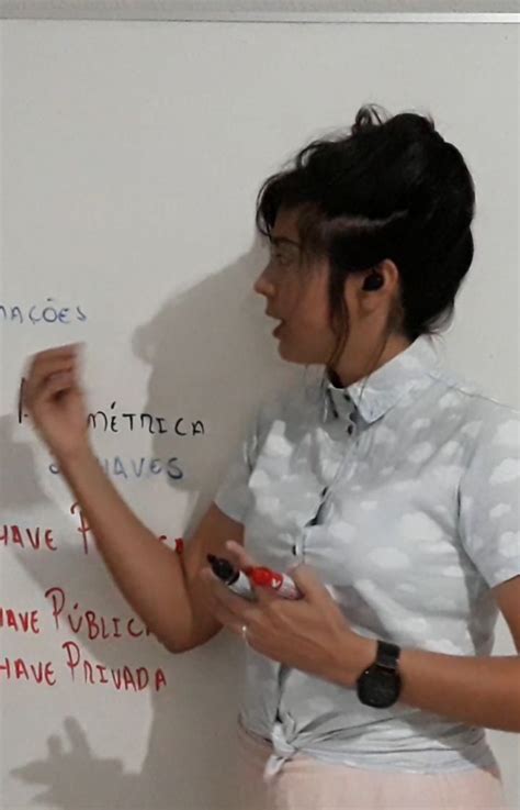 A Woman Standing In Front Of A Whiteboard Writing On It With Marker And Pen