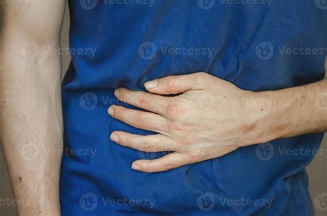A Man Holding His Stomach Close Up 3154602 Stock Photo At Vecteezy