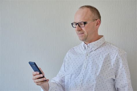 Premium Photo Handsome Middle Age Man With A Smartphone In His Hand