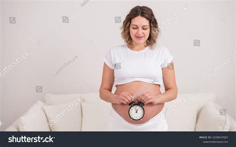 Pregnant Woman Naked Belly Holds Alarm Stock Photo 2228437667