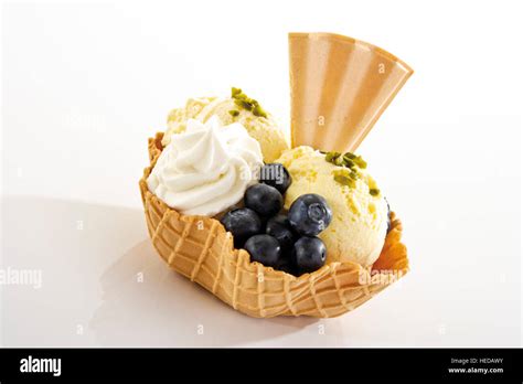 Vanilla Ice Cream Blueberries Whipped Cream And A Fan Shaped Wafer In