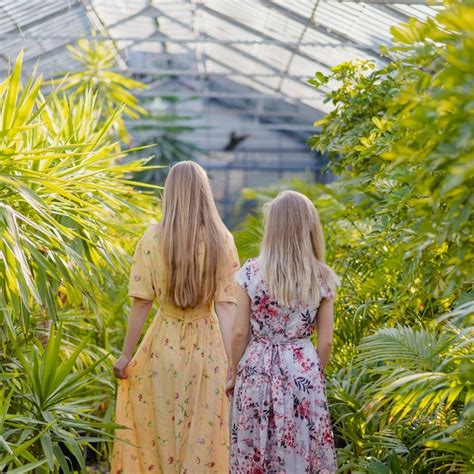Free Photo Women In Dresses Walking Through Foliage