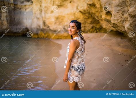 Beutiful Latin Mexican Girl Tourist Walking On Beach With Rocks On Beautiful Beach Near Ocean