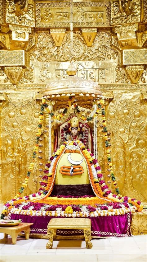 The Golden Shrine Is Decorated With Flowers And Decorations