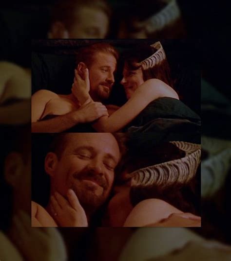 The Man And Woman Are Cuddling In Bed With Each Other While They Look