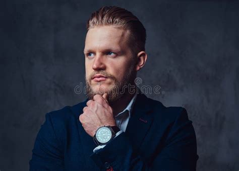 Portrait Of Stylish Blond Bearded Male Dressed In A Suit Stock Photo