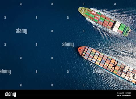 High Aerial Top Down View Of Two Container Cargo Ships Traveling Over