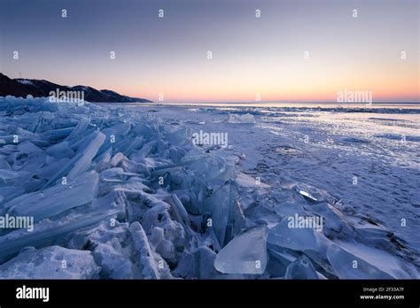 Lake Baikal In Siberia At Sunset A Pile Of Beautiful Ice Hummocks With Reflection The Natural