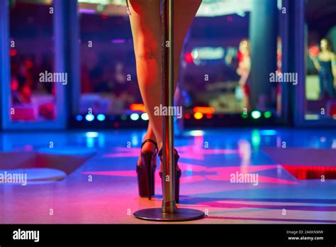 Heels Of Sexy Woman Pole Dancing Or Striptease Pylon In Night Club Stripper Girl Background