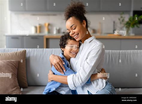Affectionate Mother And Son Hugging Warmly In Cozy Home Setting Stock