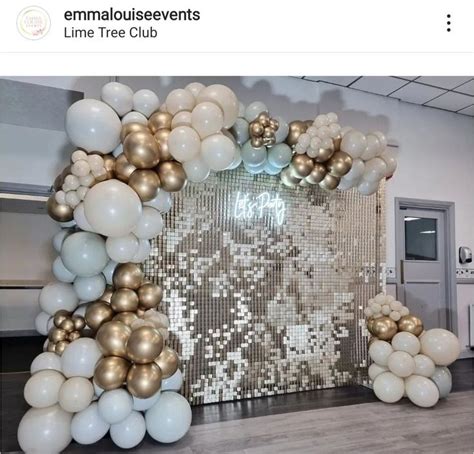 A Large Balloon Arch With Gold And White Balloons