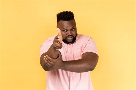 Premium Photo Man Pointing Finger Guns To Camera Looking Aggressive