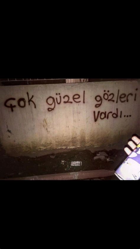 Graffiti Spray Painted On The Side Of A Wall Next To A Trash Can In An