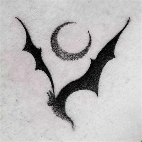 A Bat And Crescent Tattoo On Someone S Stomach
