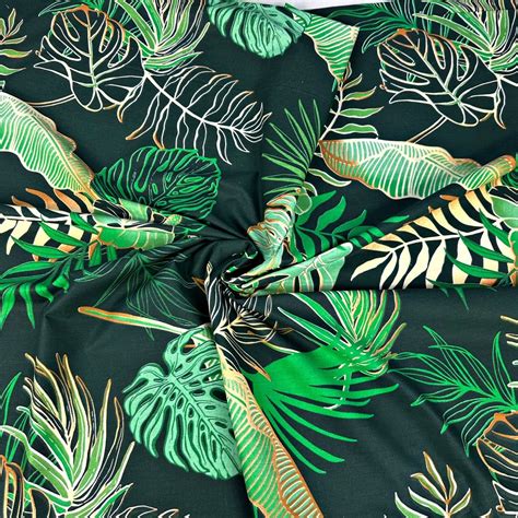 Tkanina bawełniana liście monstera i bananowca z kwiatami na zielonym