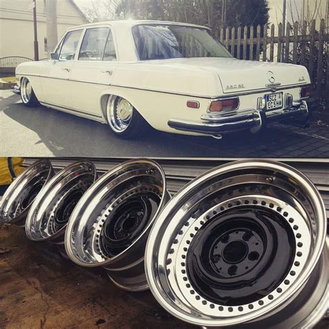 An Old White Car Is Parked In Front Of Some Rims