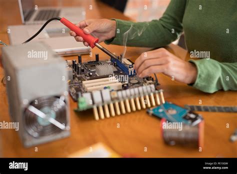 Female Electrical Engineer Soldering A Circuit Board Stock Photo Alamy