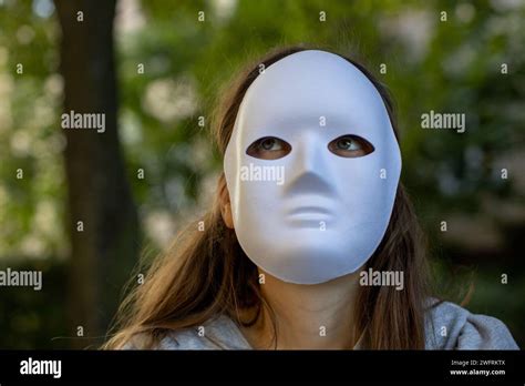 Woman With Full Face White Mask Sitting In The Woods Stock Photo Alamy