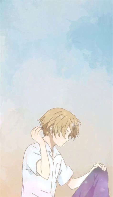 A Man Sitting On The Ground With His Hand To His Face